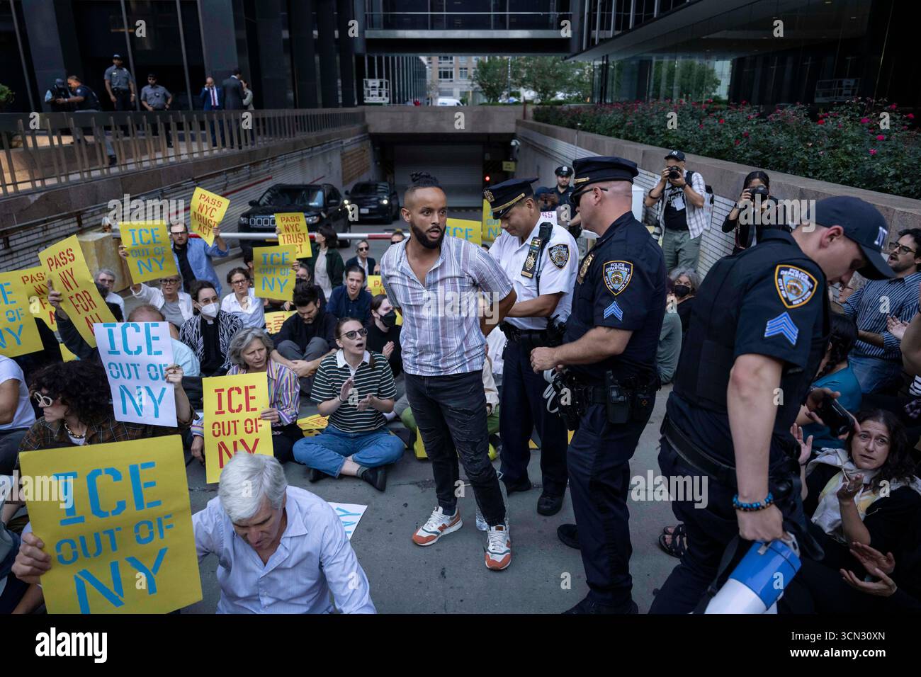 NYPD officers detain demonstrators during a protest against Immigration ...