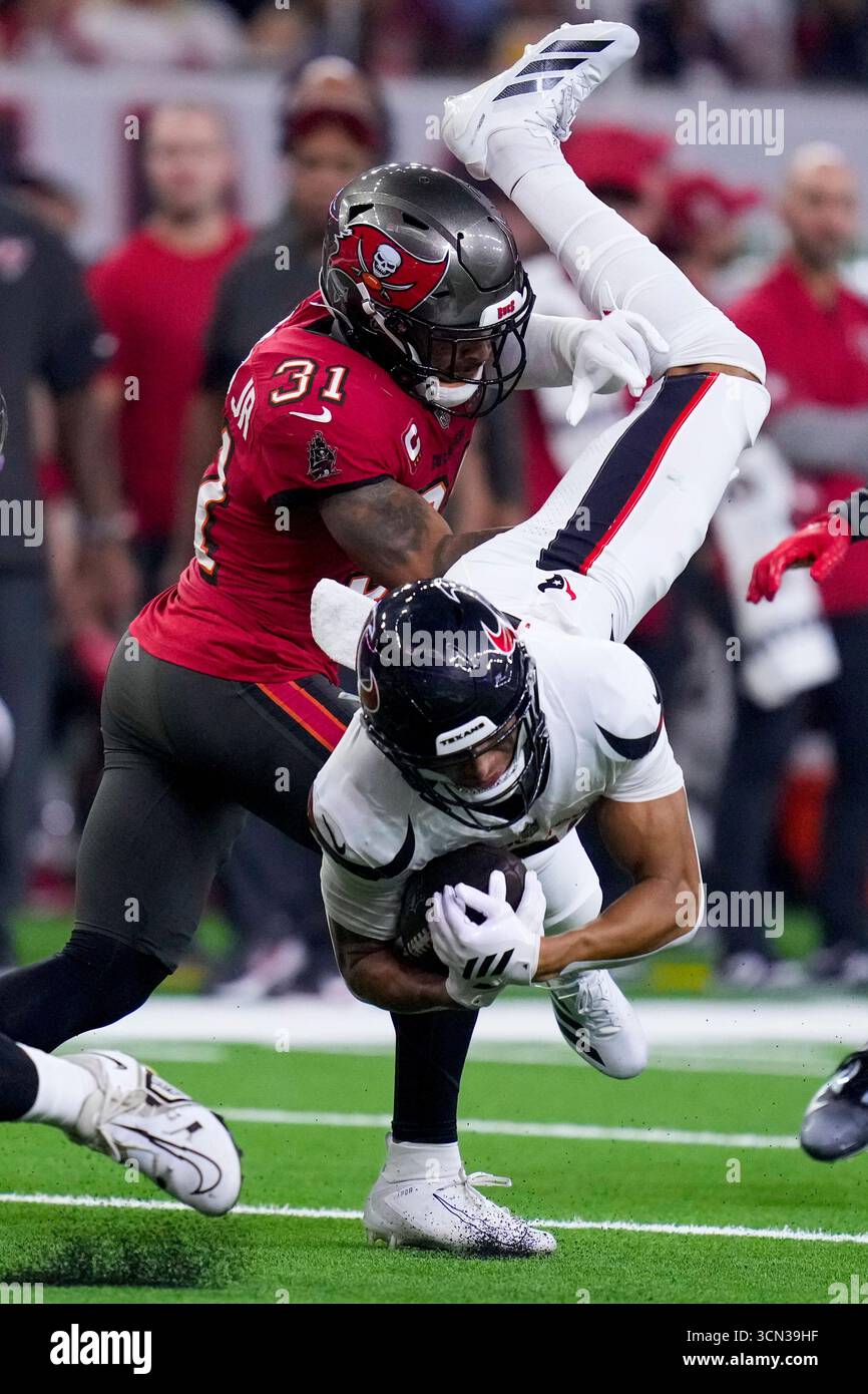 Houston Texans wide receiver Jayden Higgins, right, is tackled by Tampa Bay Buccaneers safety ...