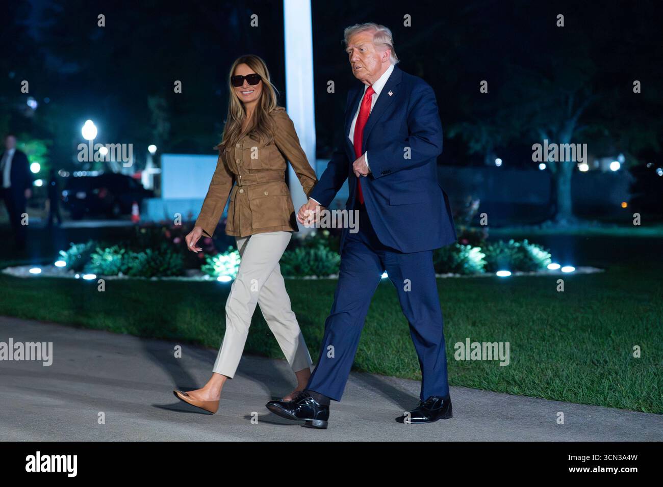 President Donald Trump holding hands with the first lady Melania Trump ...