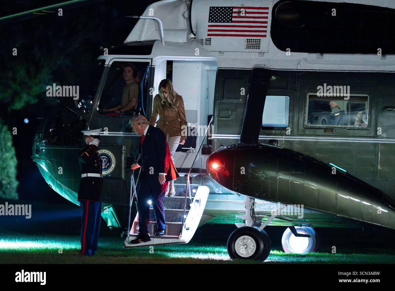 President Donald Trump and first lady Melania Trump step off Marine One ...