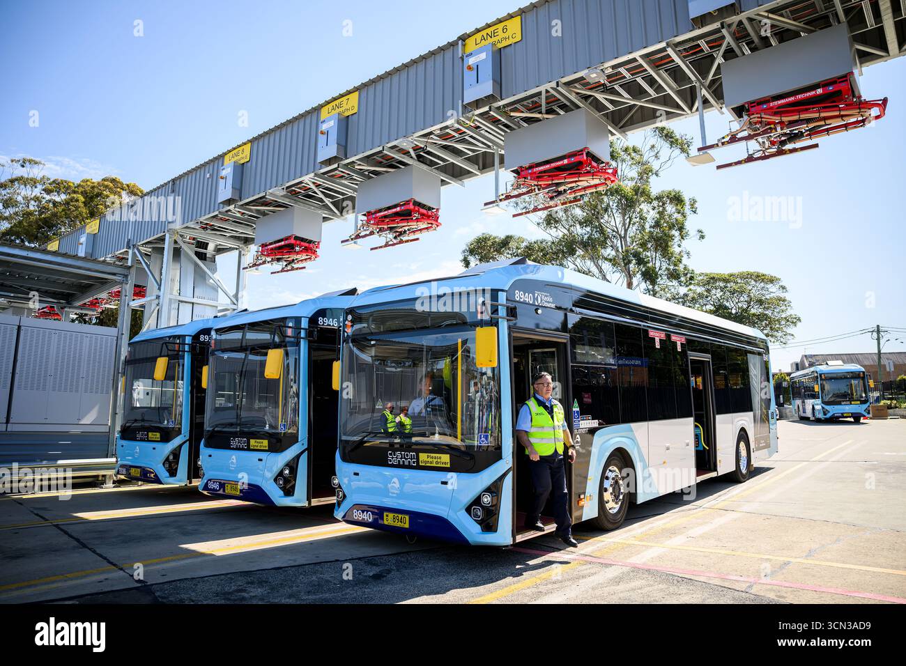 Electric battery buses are seen under the gantry-mounted fast-charging ...