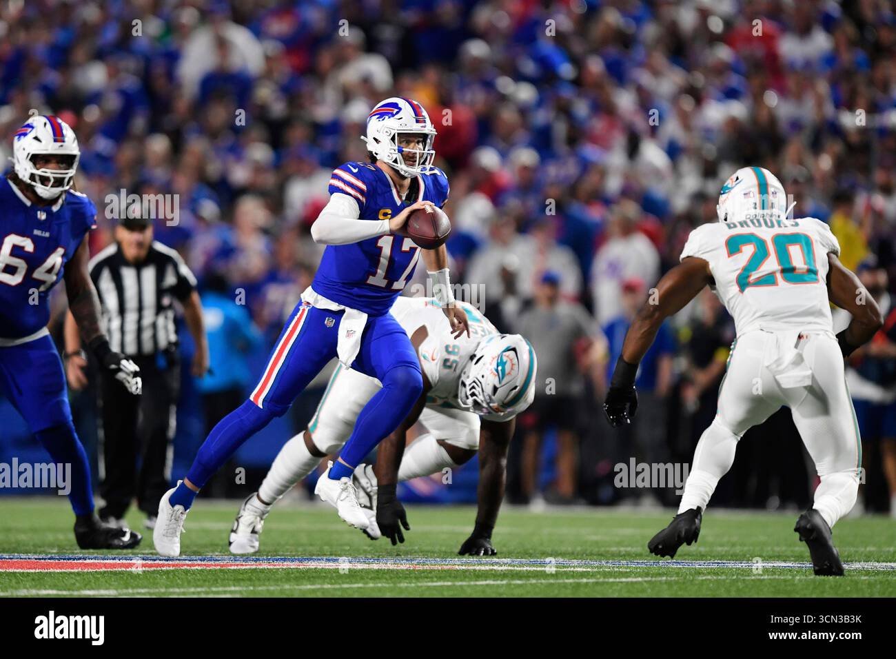 Buffalo Bills quarterback Josh Allen (17) runs with the ball during the first half of an NFL ...