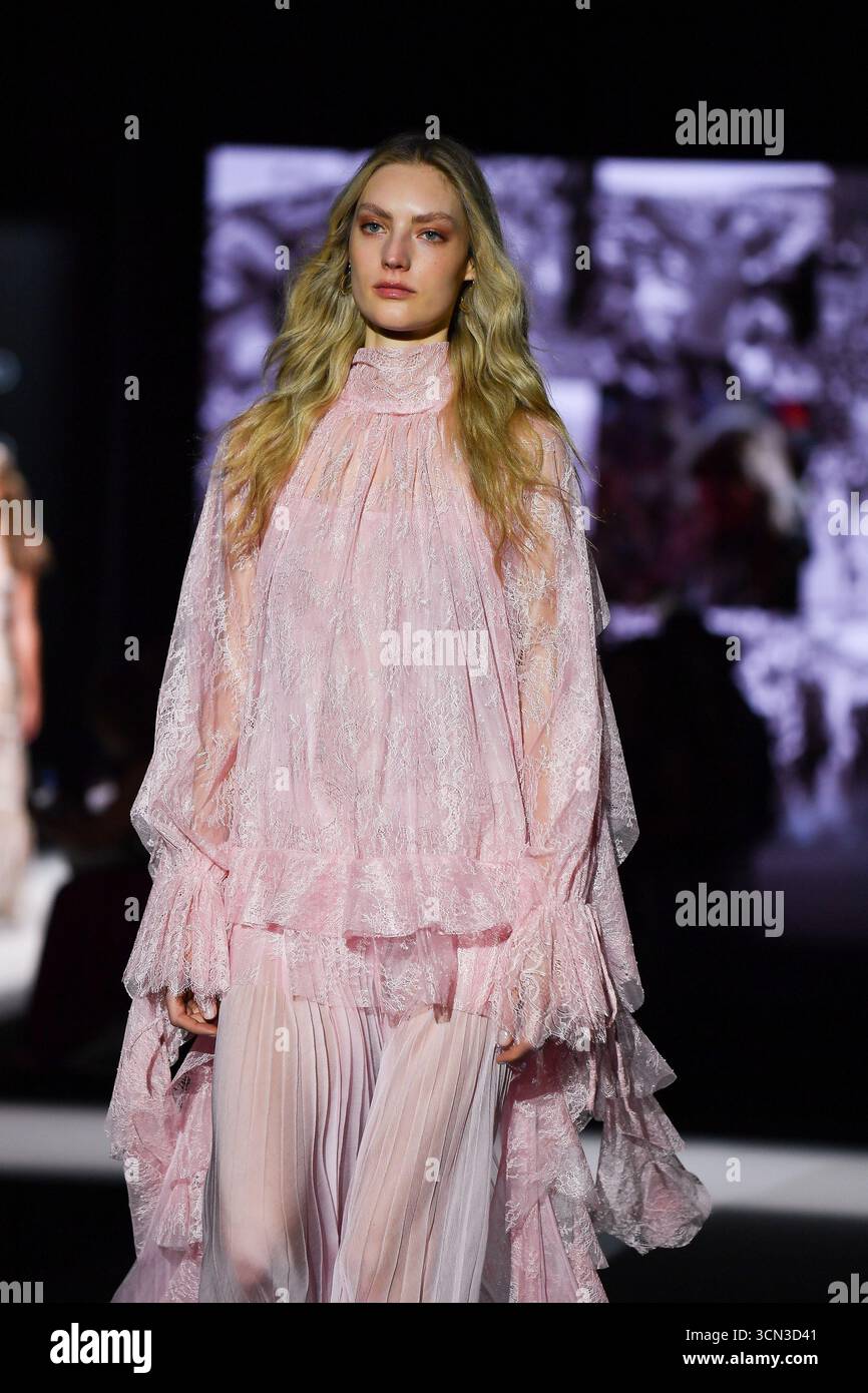 Madrid, Spain. 18th Sep, 2025. A model walks the runway wearing a ...