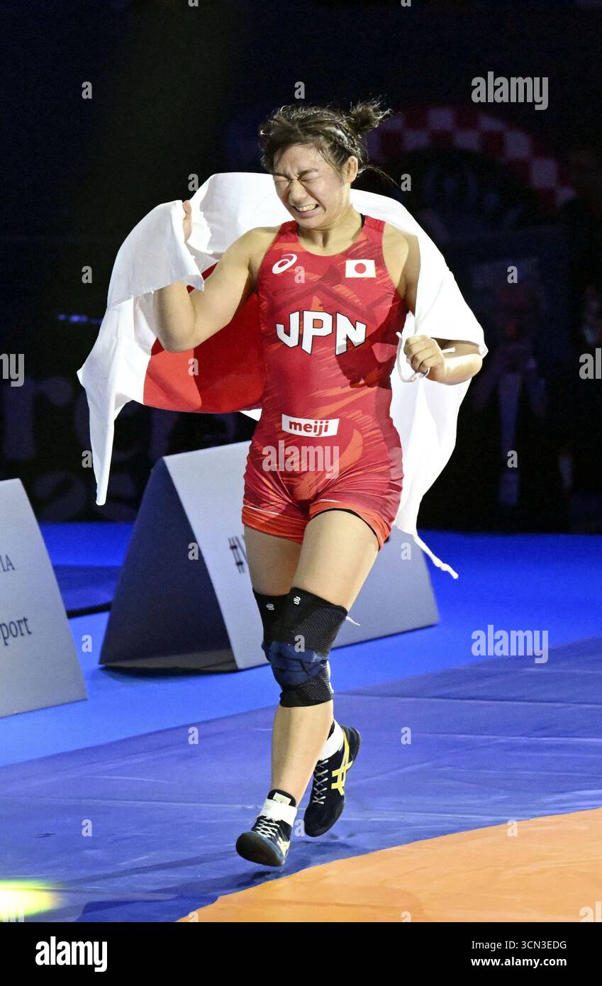 Sakura Motoki of Japan celebrates with a national flag after defeating ...