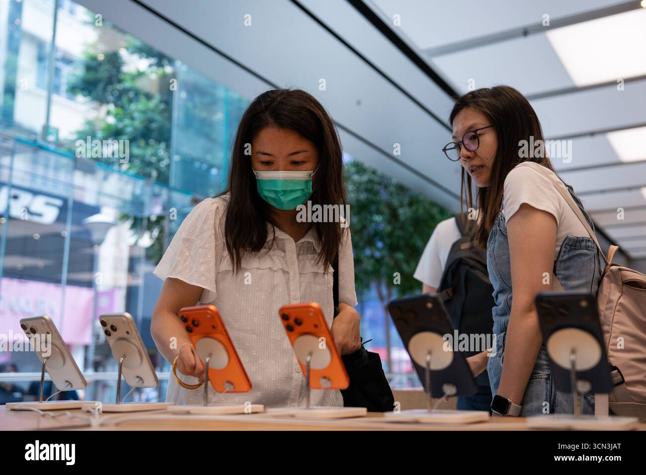 People looking at iPhone 17’s inside the Apple Store in Causeway Bay on ...