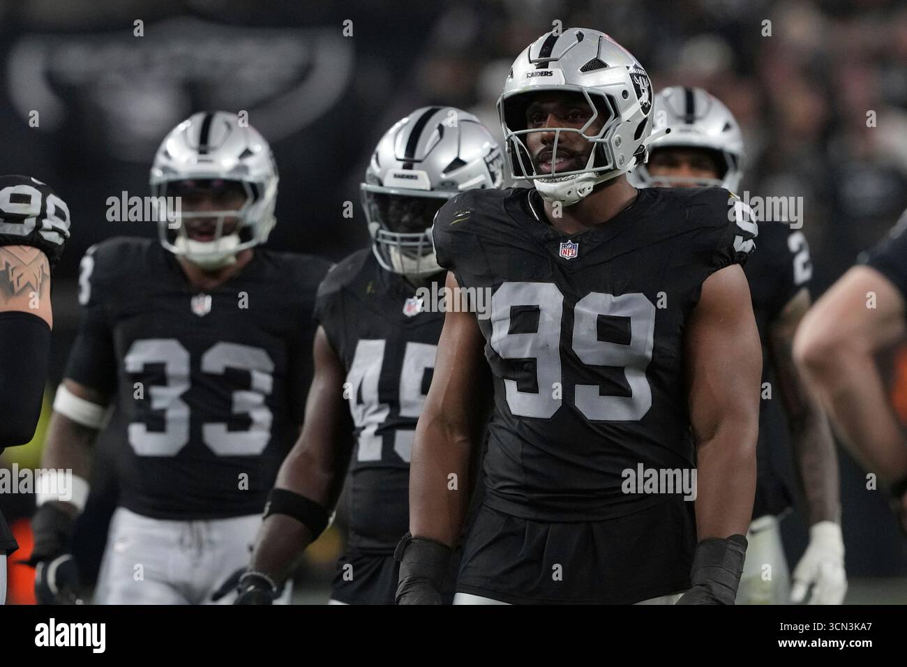 Las Vegas Raiders defensive tackle Thomas Booker (99) lines up against ...