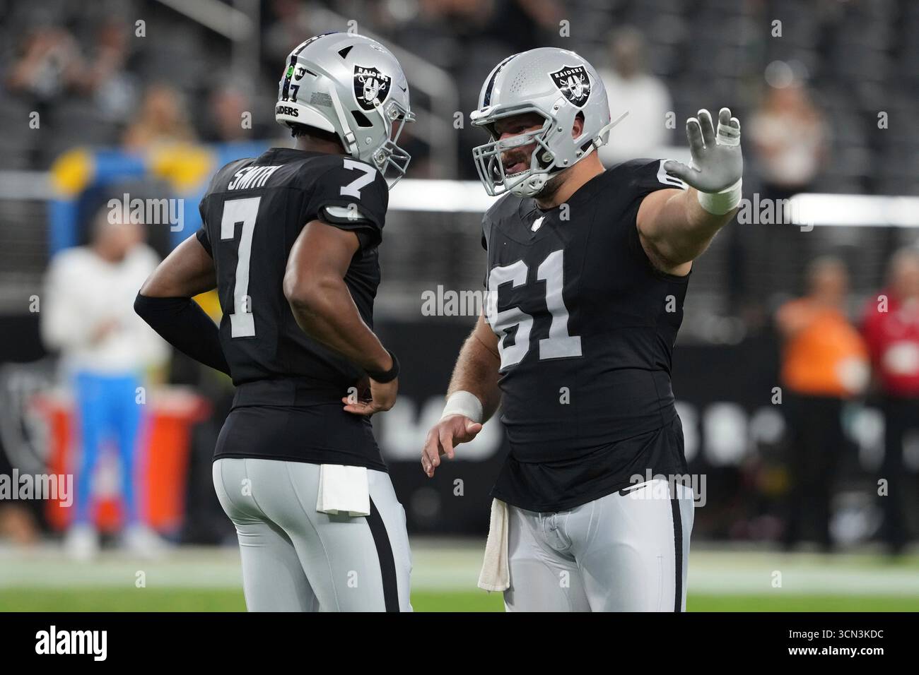 Las Vegas Raiders quarterback Geno Smith (7) and guard Jordan Meredith ...