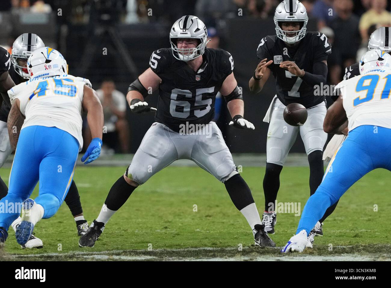 Las Vegas Raiders guard Alex Cappa (65) blocks against the Los Angeles ...