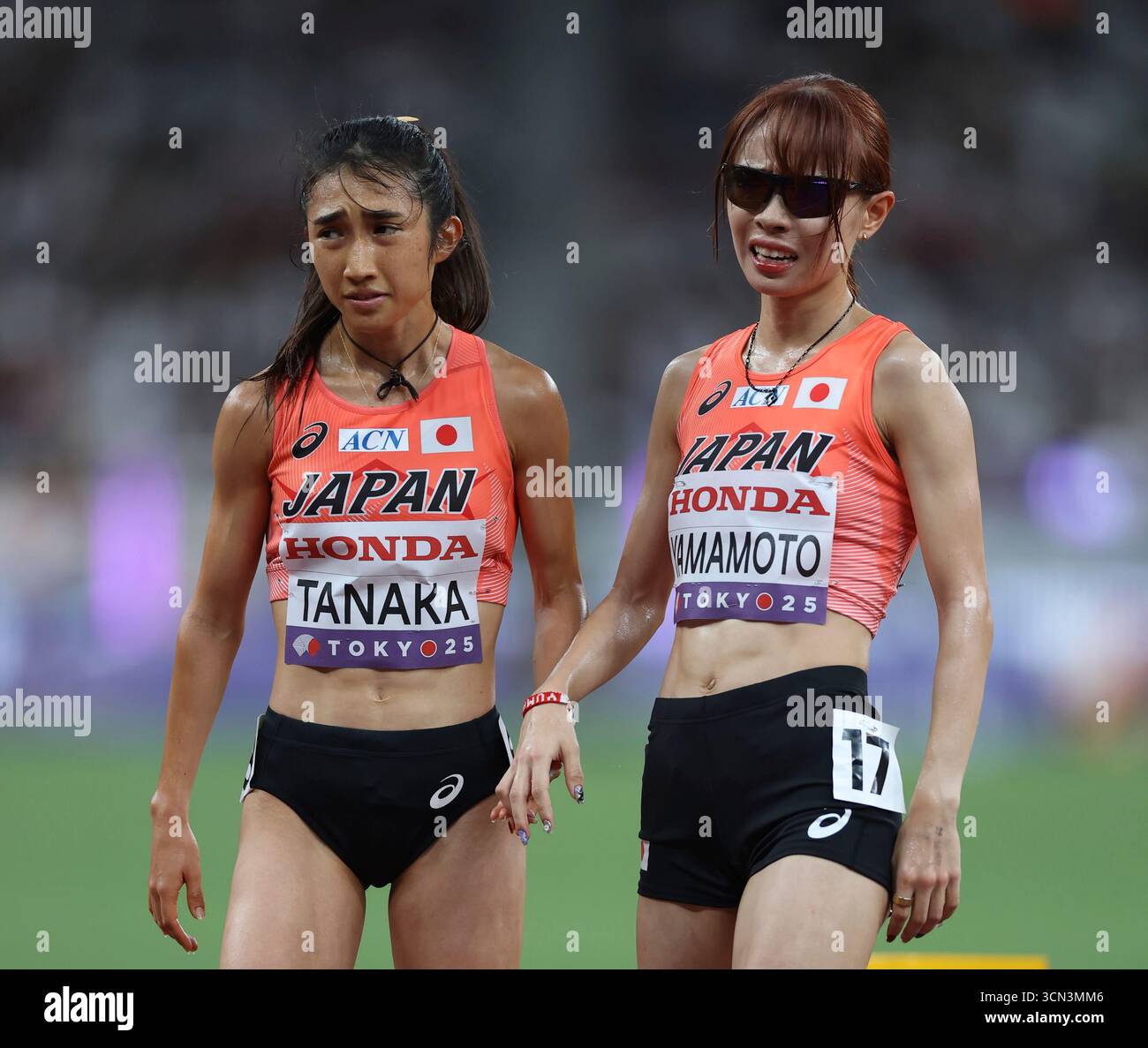 Japanese Yuma YAMAMOTO (R) and Nozomi TANAKA congratulate after finishing the women's 5000 ...
