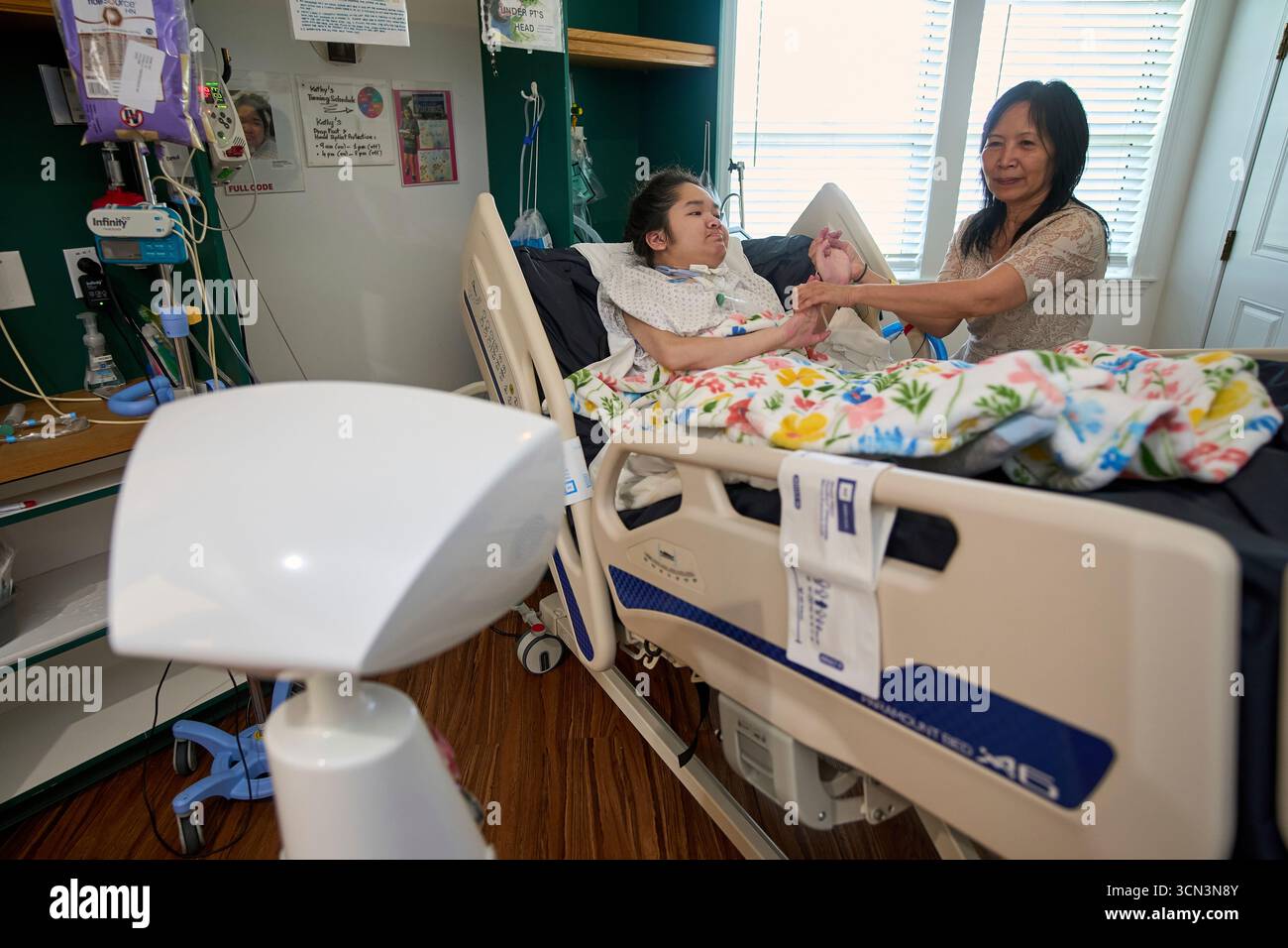 Cara Nguyen with her daughter, Kathy, 18, are visited by Robin the ...