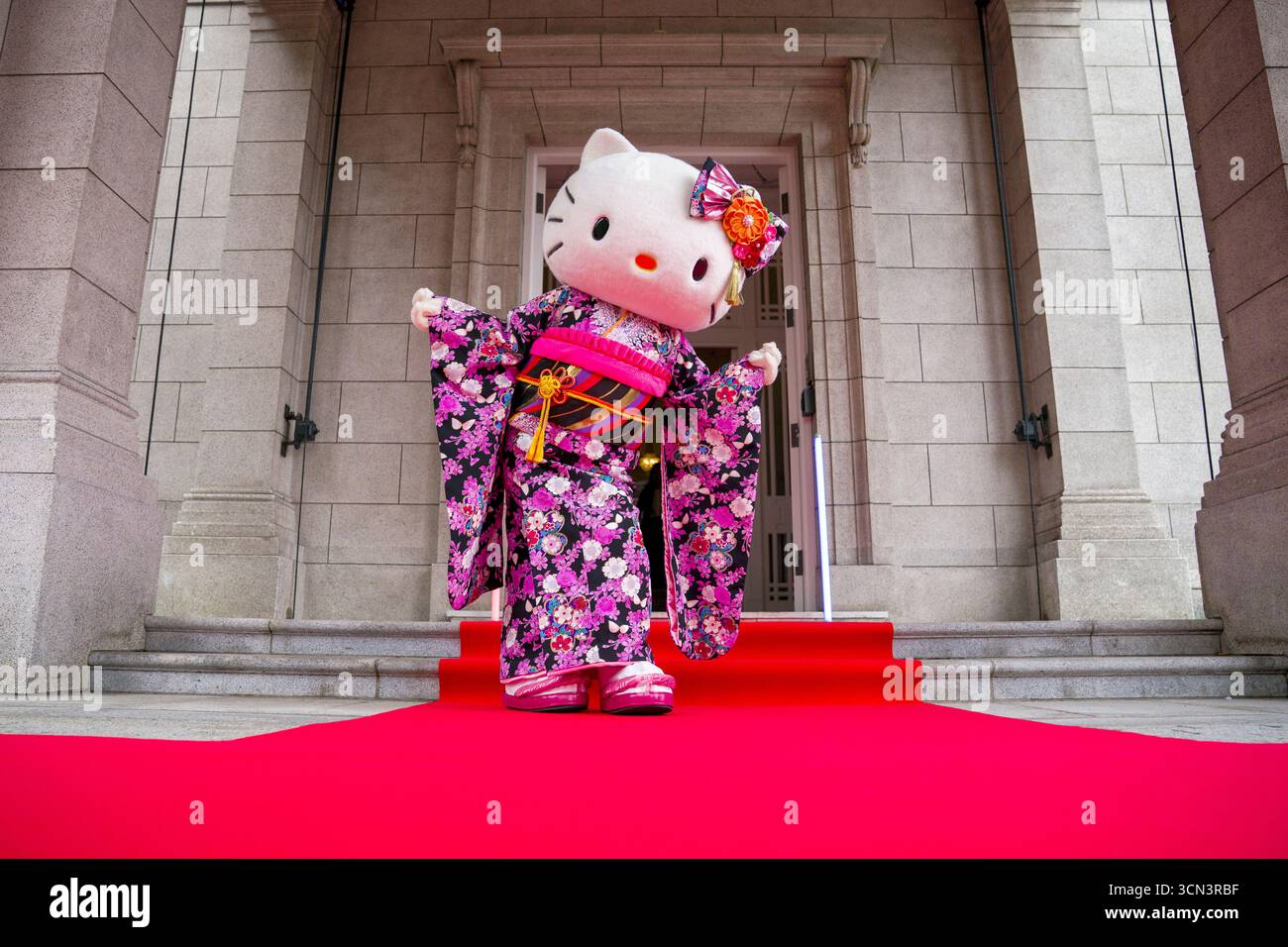 A person dressed as Hello Kitty greets guests as they arrive at the ...