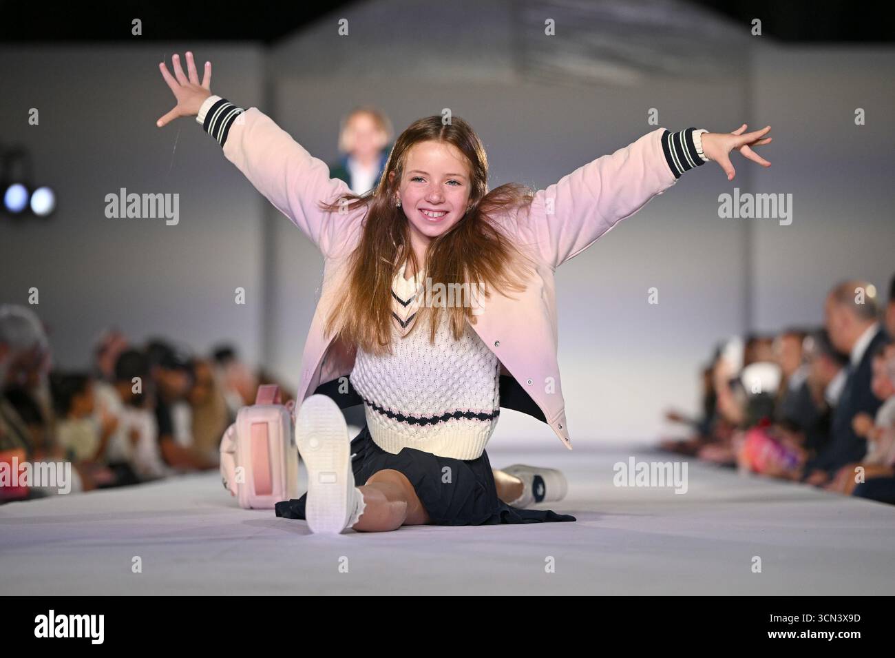 A young model does the splits as she walks the runway during the 'Macy ...