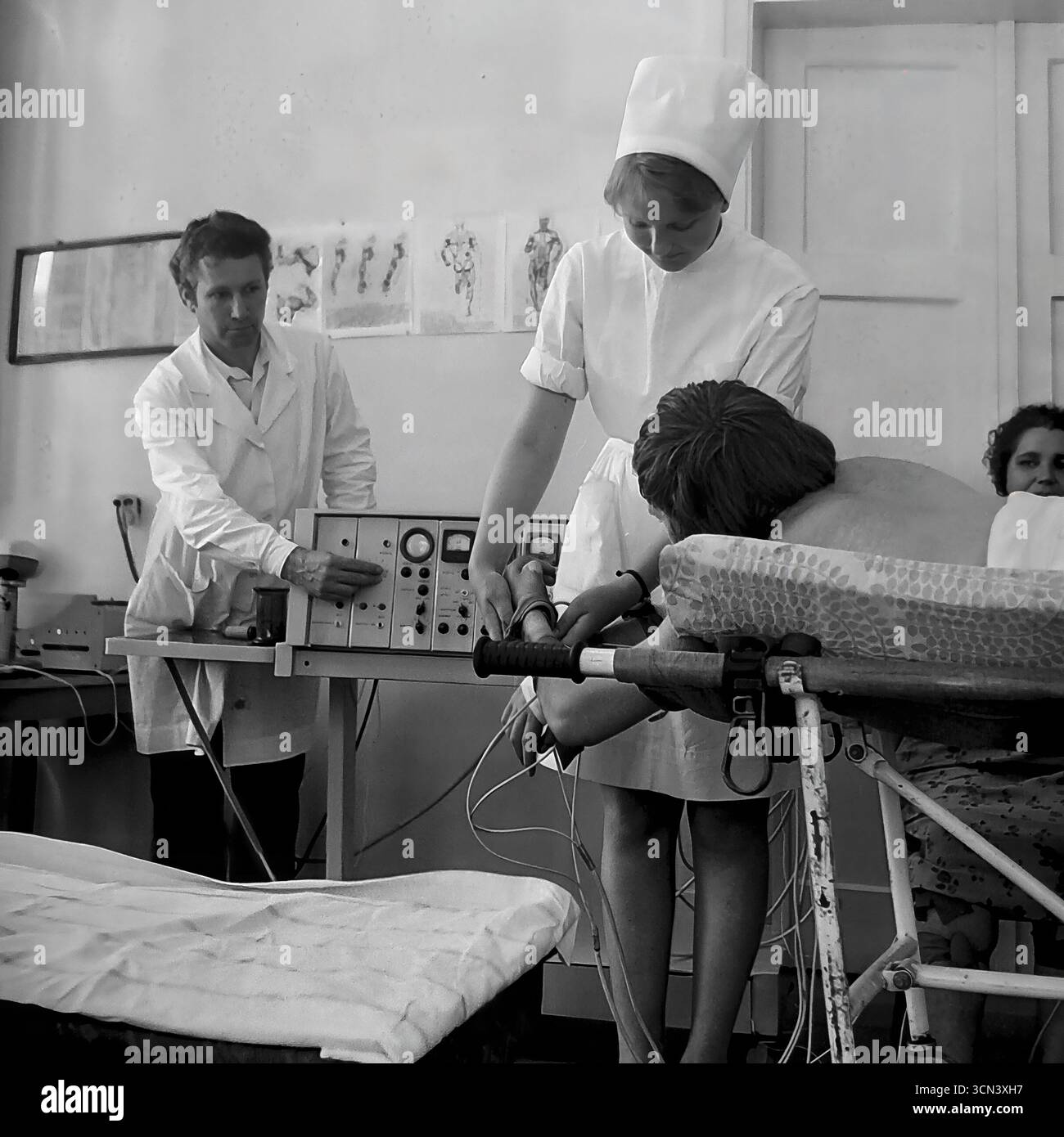 A historical photograph from the 1970-80s, showing the teamwork of a ...