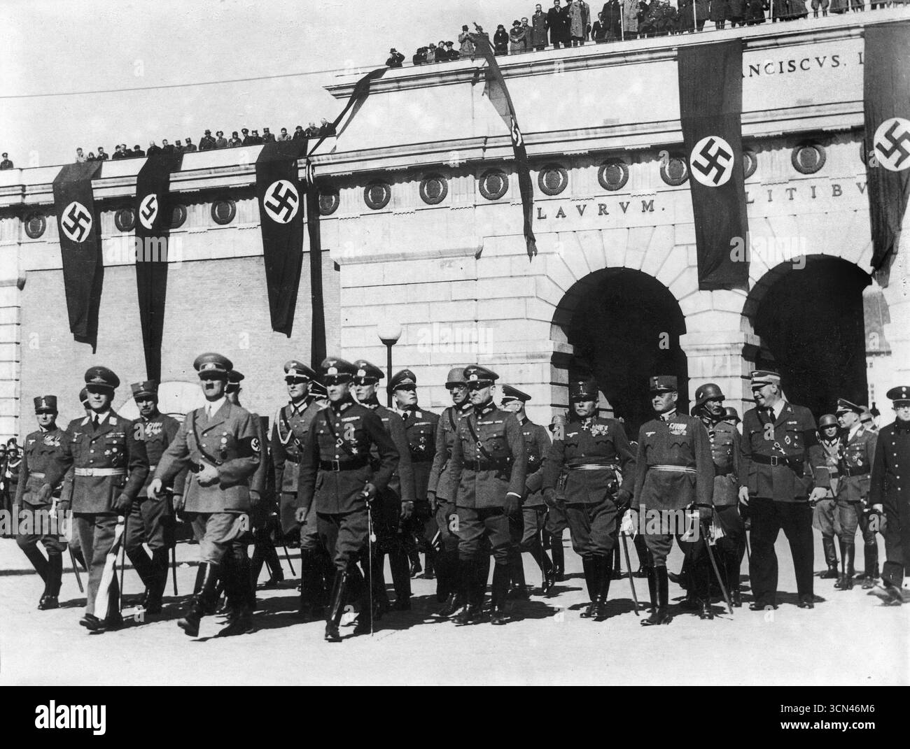 Adolf Hitler accompanied by German and Austrian officers at Heldenplatz ...
