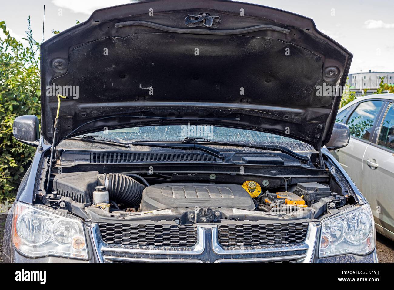 Jumpstart a dead car battery using a power bank in the parking lot ...