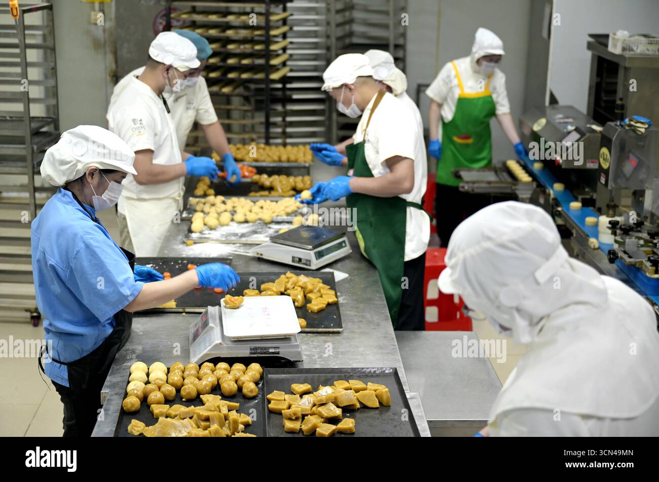 Employees make mooncakes at a food workshop in Haian City, east China's ...