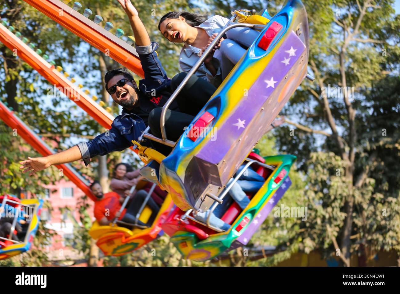 Friends Enjoying Thrilling Swing Ride - Exciting Amusement Park ...