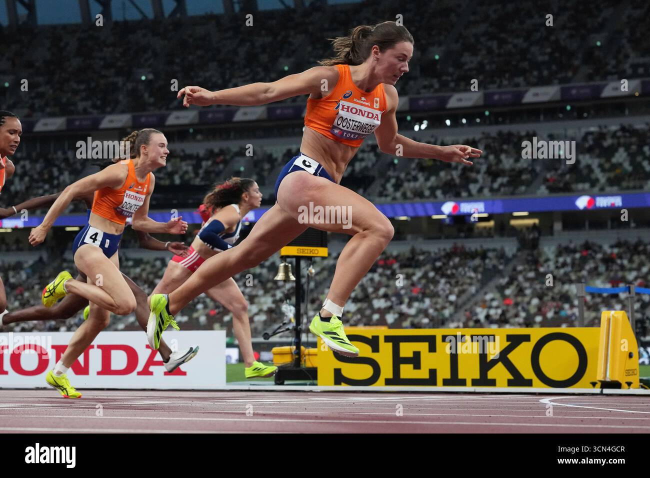 Netherlands' Emma Oosterwegel, foreground, crosses the finish line ...