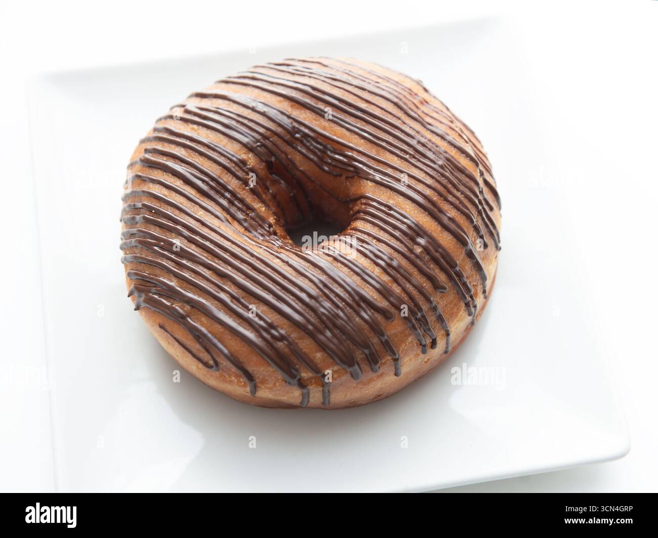 Delicious chocolate glazed donut with a glossy finish, elegantly placed ...