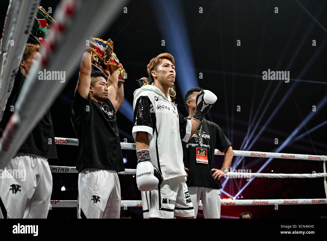 Champion Japan's Naoya Inoue stands with his brother Takuma Inoue, left ...