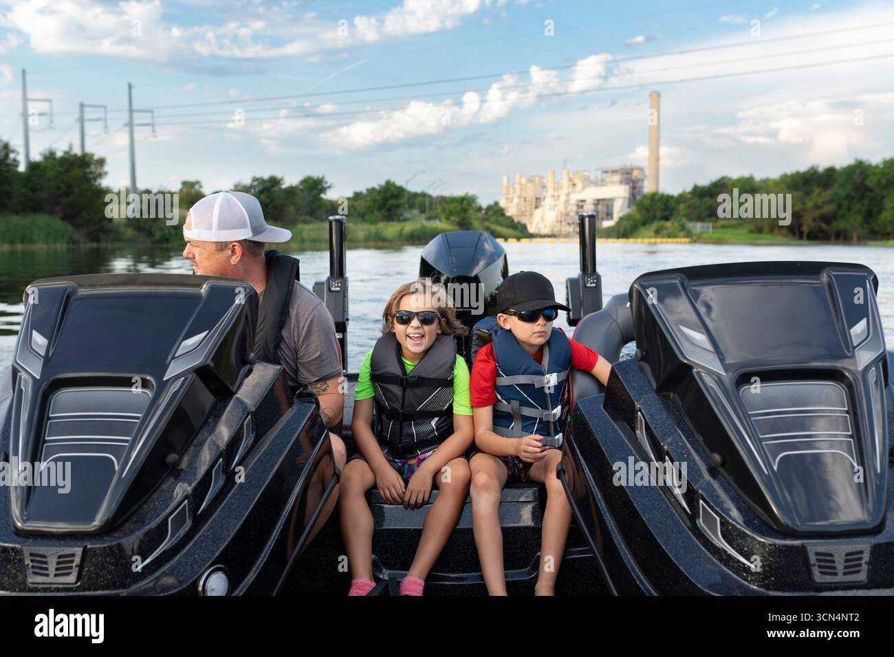 Family on a fishing boat enjoying a summer lake outing Stock Photo - Alamy