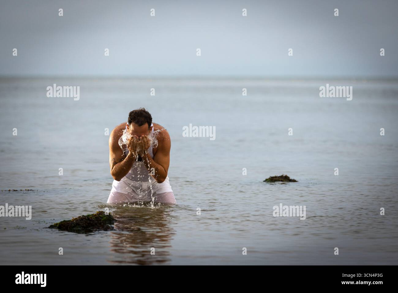 Man wearing white dancing in the beach on Cape Cod during the pi Stock ...