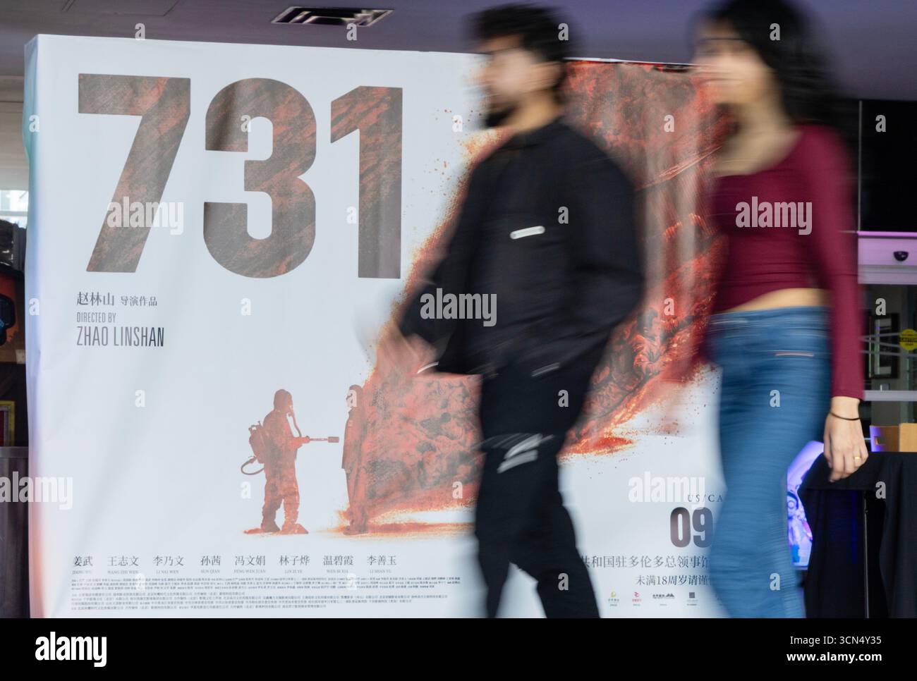 Toronto, Canada. 18th Sep, 2025. People walk past a poster of the film ...