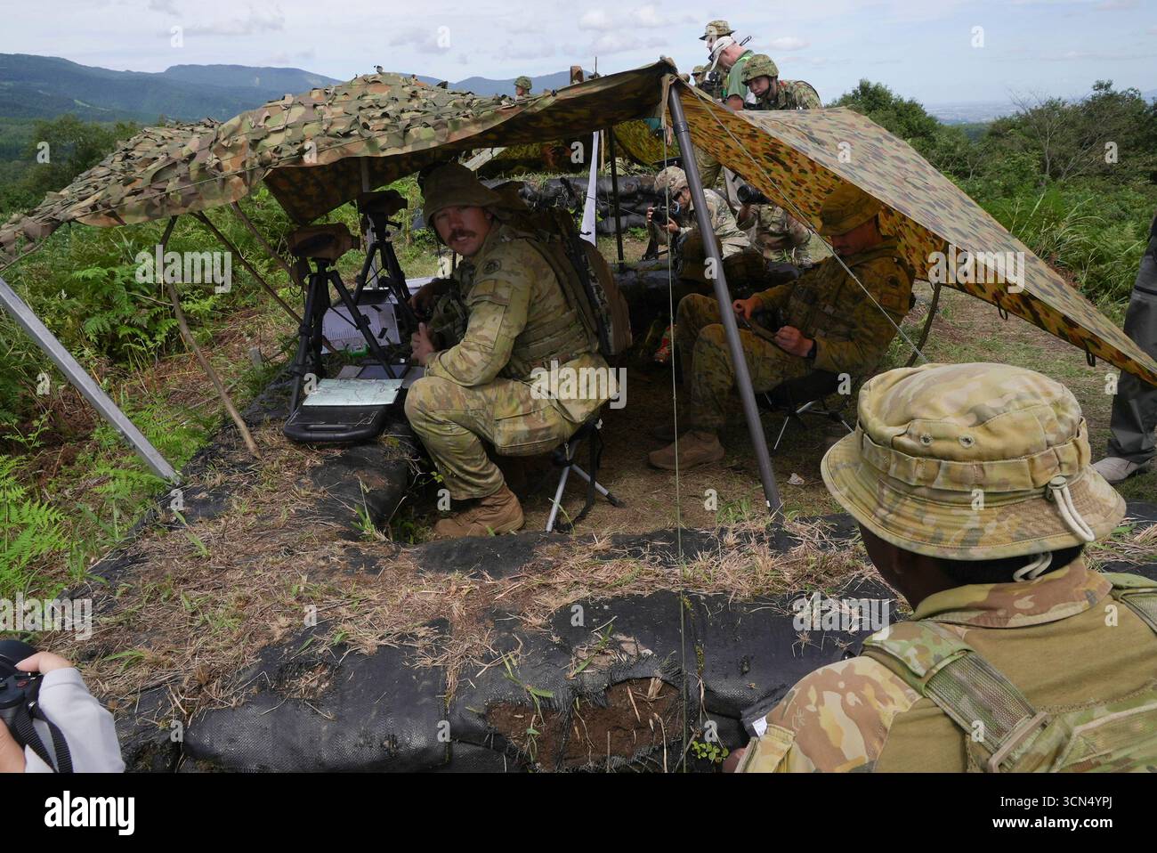 Members of the Australian Army are on standby at an observation deck ...