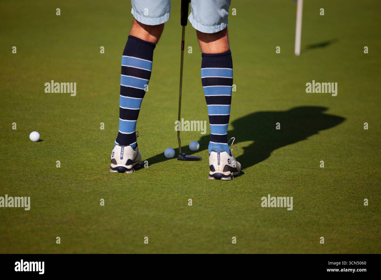 Close-up of a golfer s feet while putting, illustration of the St ...