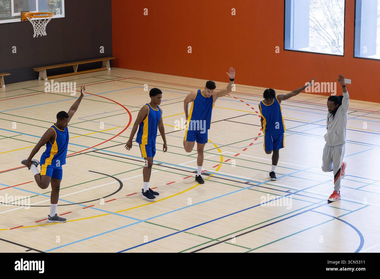 Raising basketball overhead male hi-res stock photography and images ...