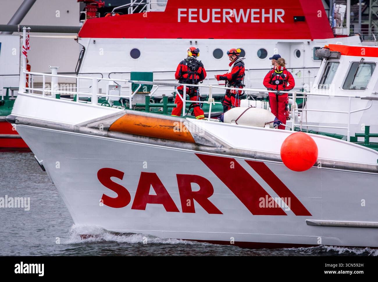 Rostock, Germany. 19th Sep, 2025. Rescue workers stand on board the ...