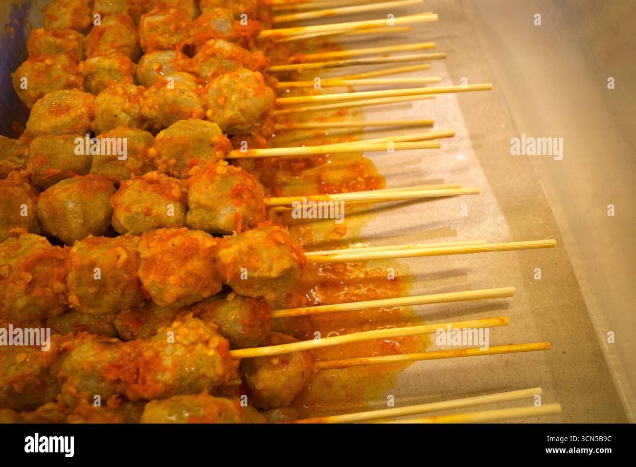 Bakso Tusuk, Indonesian chicken meatball skewer with chili sauce Stock ...