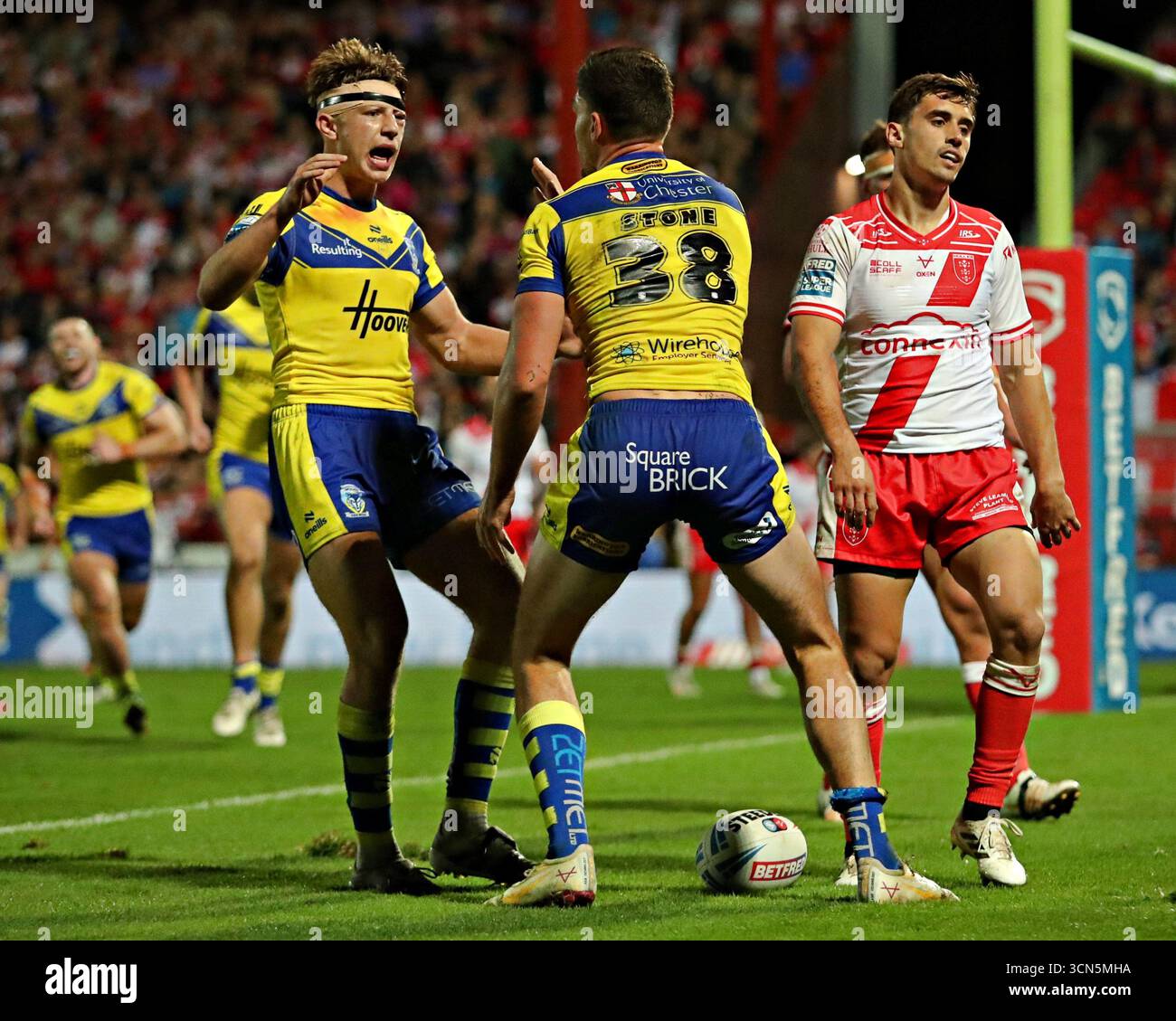 Sam Stone of Warrington Wolves celebrates his try during the Betfred ...