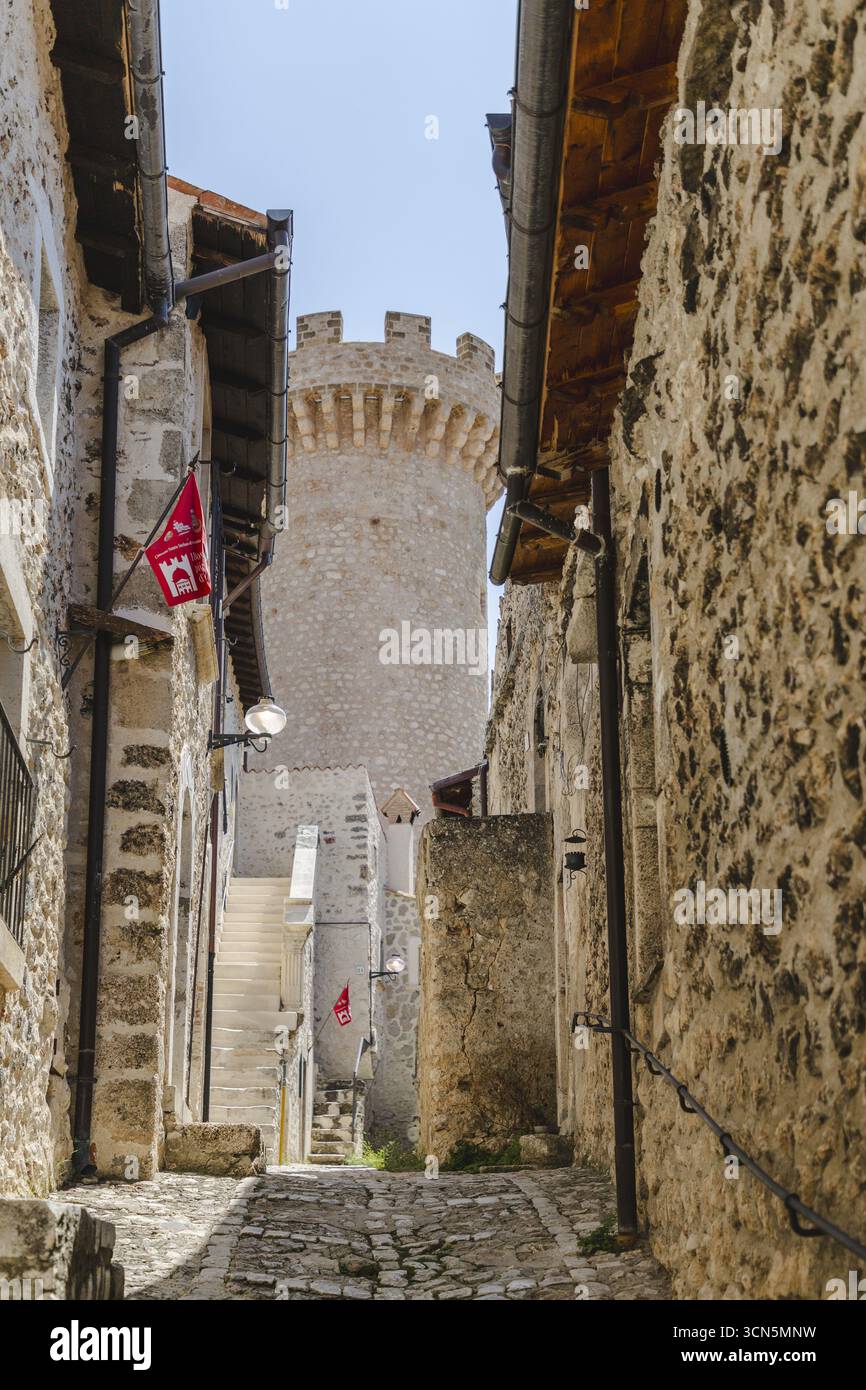 View of ancient stone buildings rise along a narrow cobblestone street ...