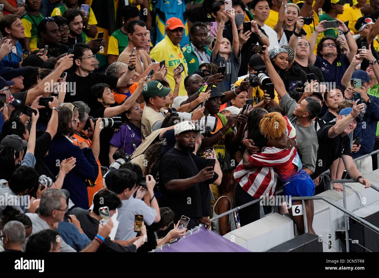 United States' Noah Lyles, having a U.S. flag, gets a hug from an ...