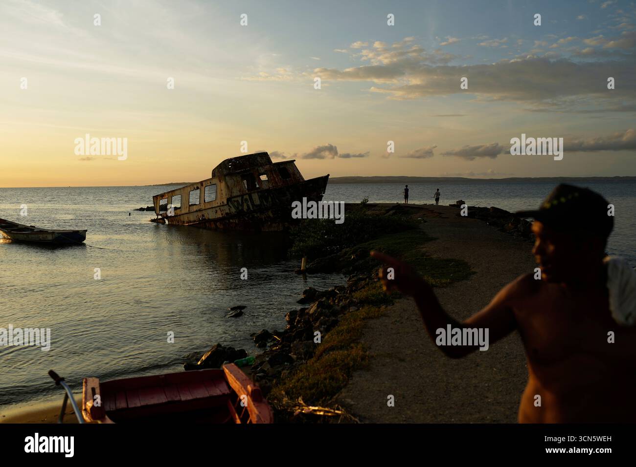 A boat sits stranded along the shore in Cumana, capital of Venezuela's ...