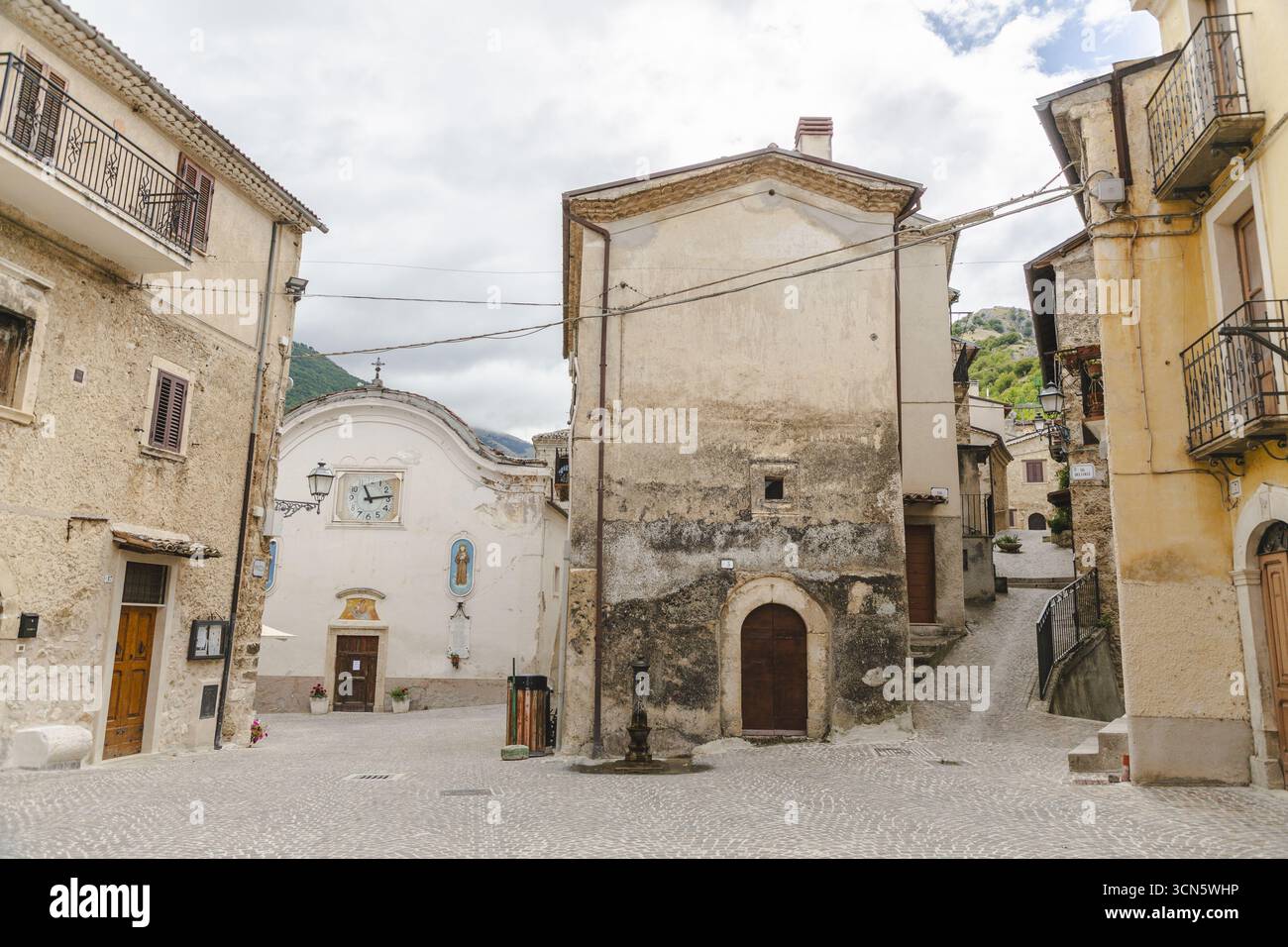 View of sun-drenched buildings cluster around a quaint square, where an ...