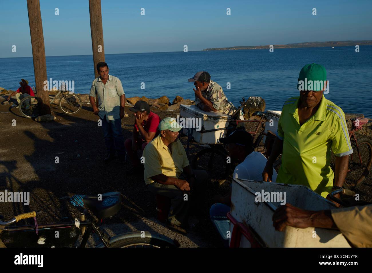 People wait to buy fish in Cumana, capital of Venezuela's Sucre state ...