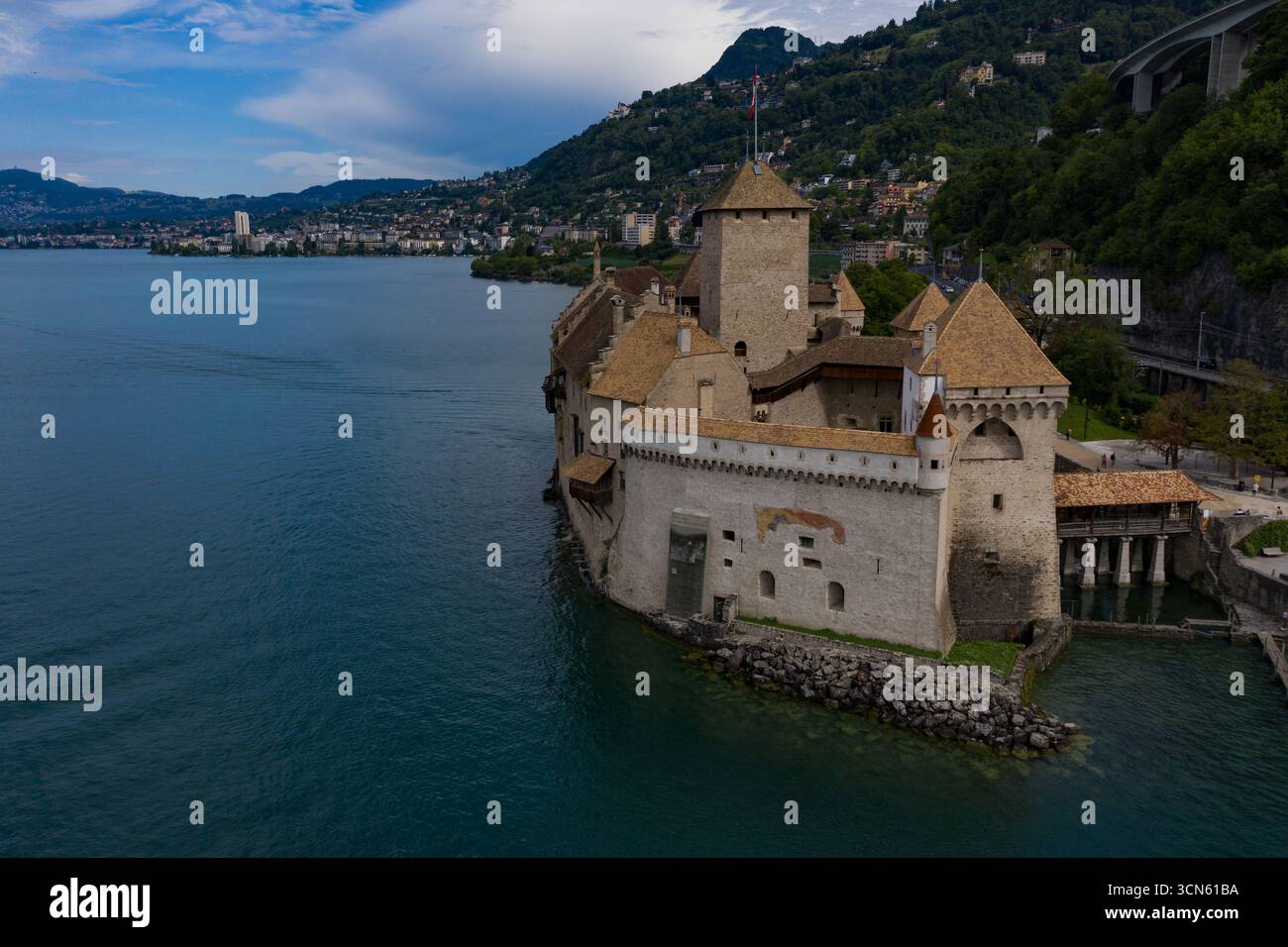 Aerial view of the imposing Chillon Castle, its stone walls meeting the ...