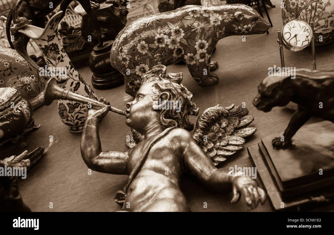 Flea market in Paris., France. Golden baby angel playing on trumpet ...