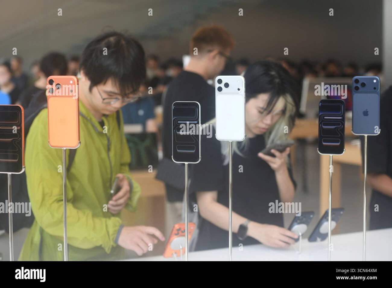 People try iPhone 17 handsets in an Apple Store in Hangzhou in east ...