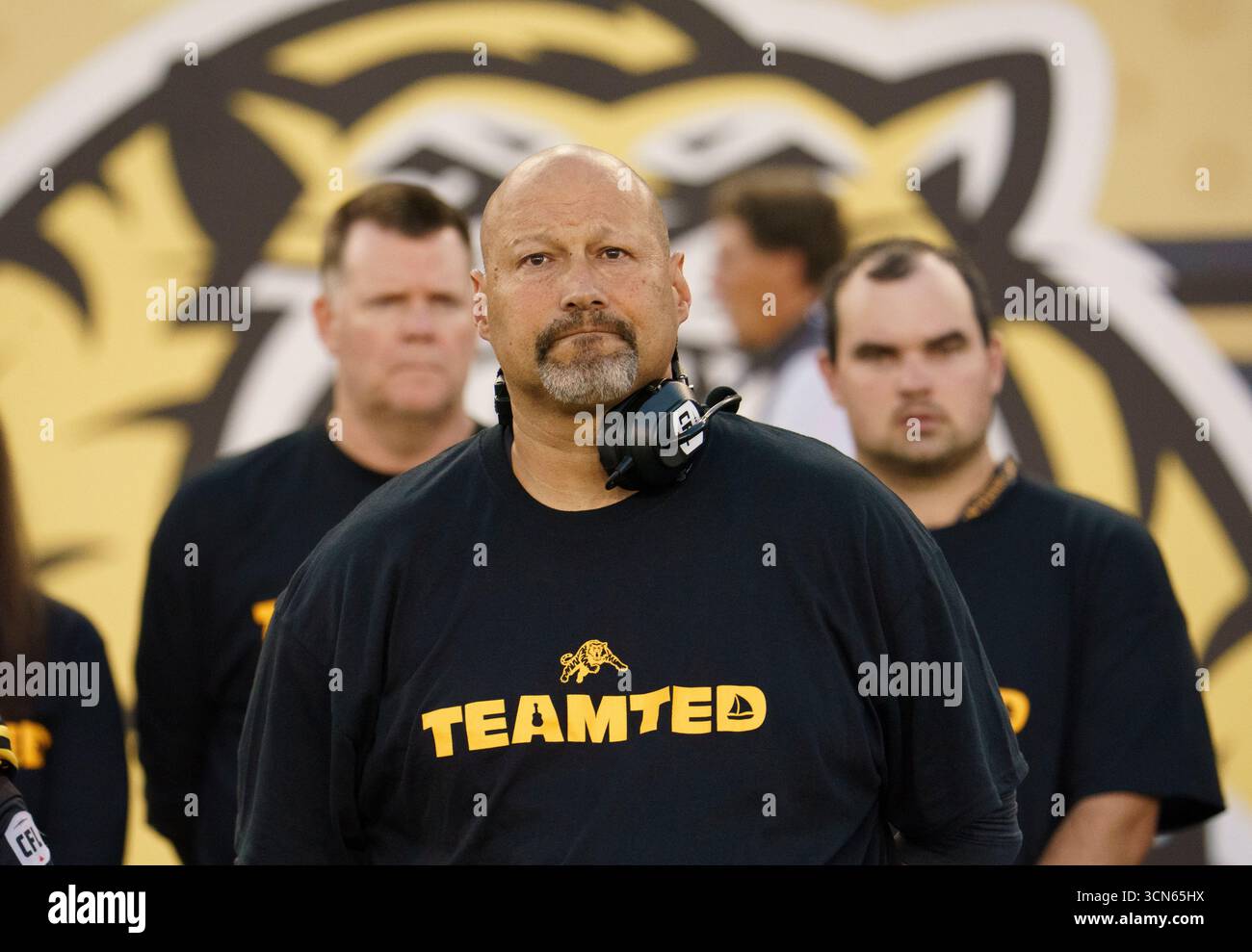 Hamilton Tiger-Cats head coach Scott Milanovich stands as they honour ...