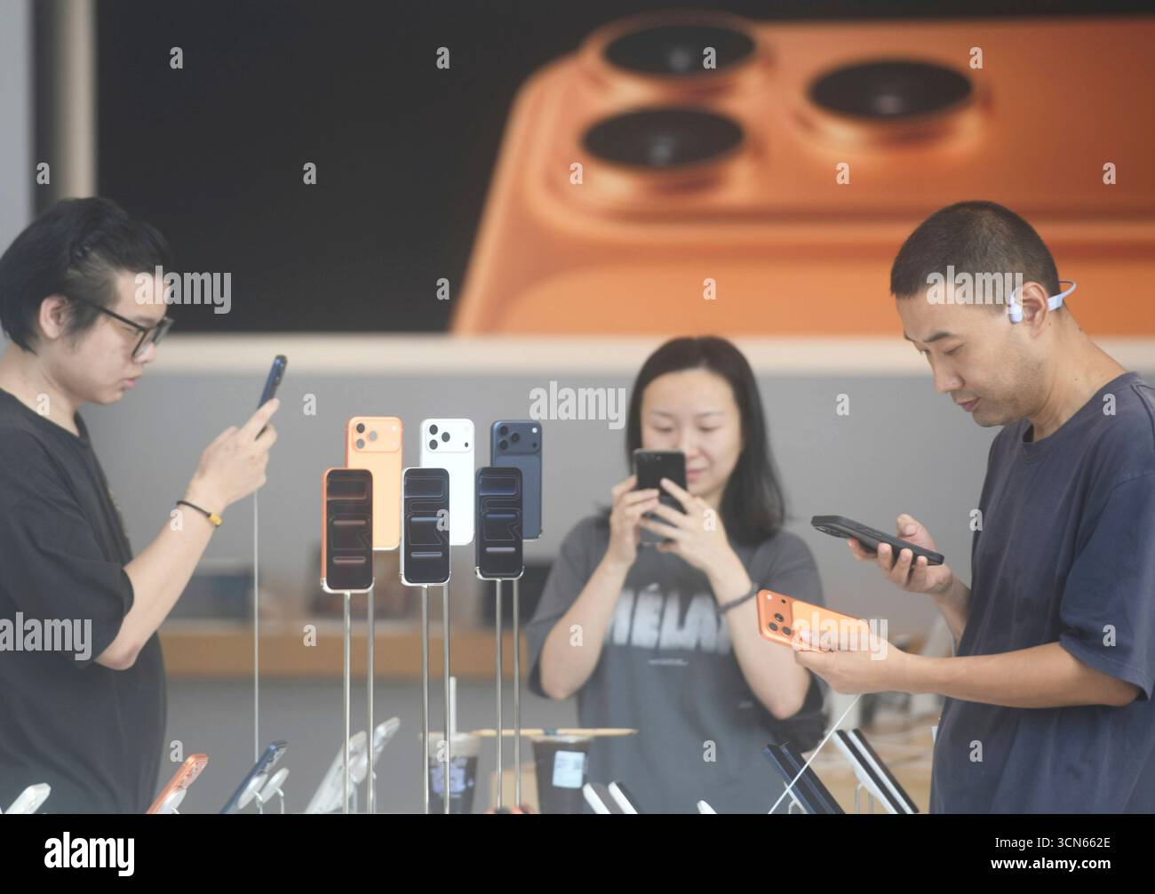 People try iPhone 17 handsets in an Apple Store in Hangzhou in east ...