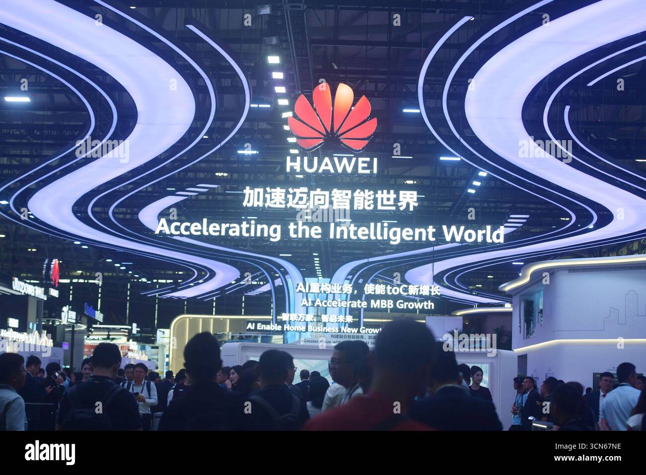People stop by the booth of Huawei at the World Mobile Communications ...