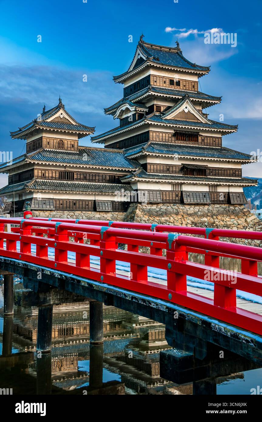 Matsumoto Castle and the red wooden bridge crossing the moat. Nagano ...