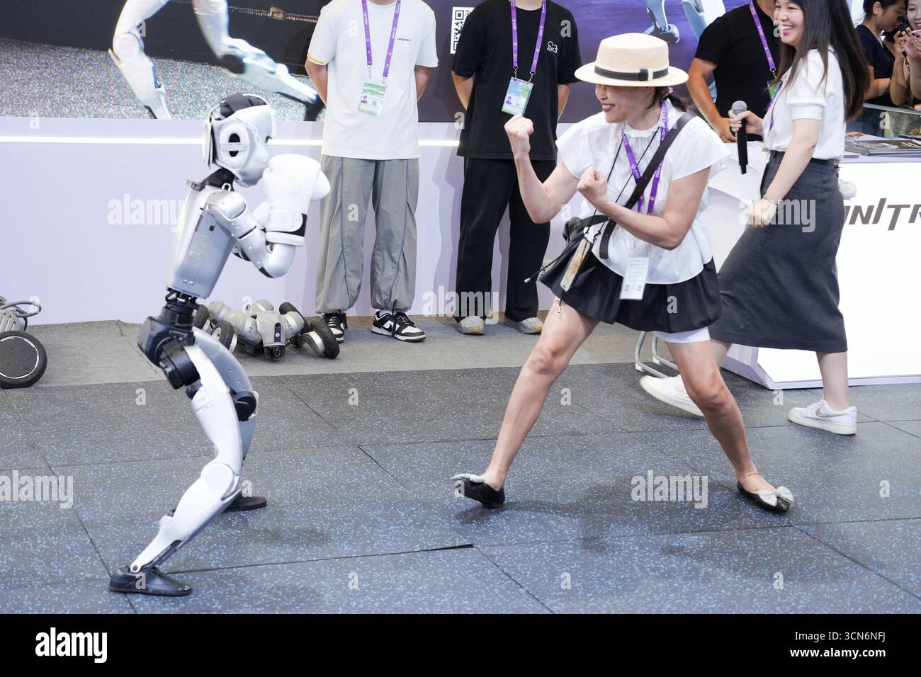 (250919) -- NANNING, Sept. 19, 2025 (Xinhua) -- A humanoid robot performs boxing with a visitor ...