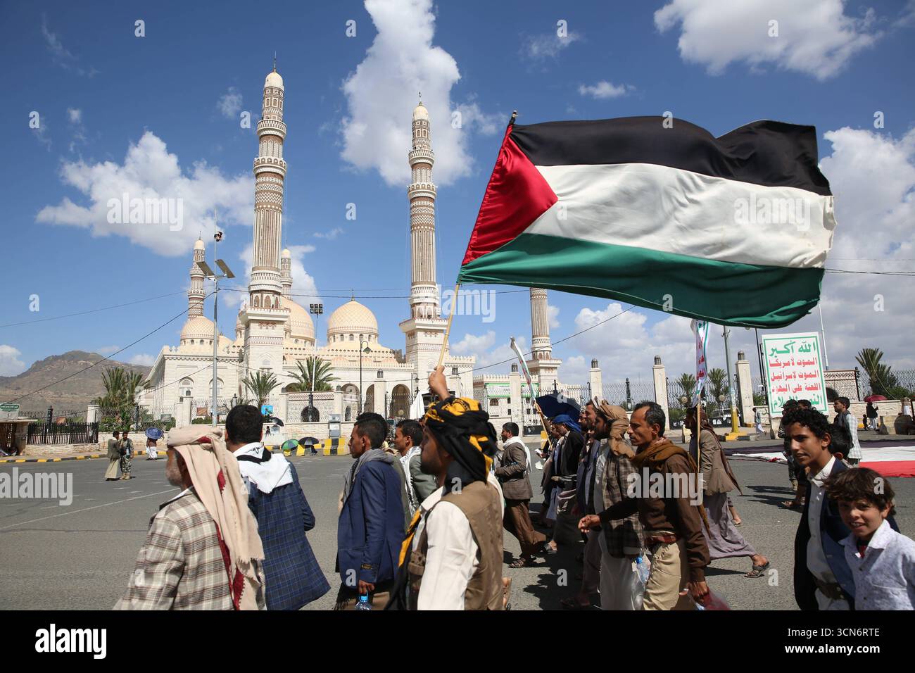 Houthis hold anti-Israel protest in Sana a- A Houthi supporter holds up ...