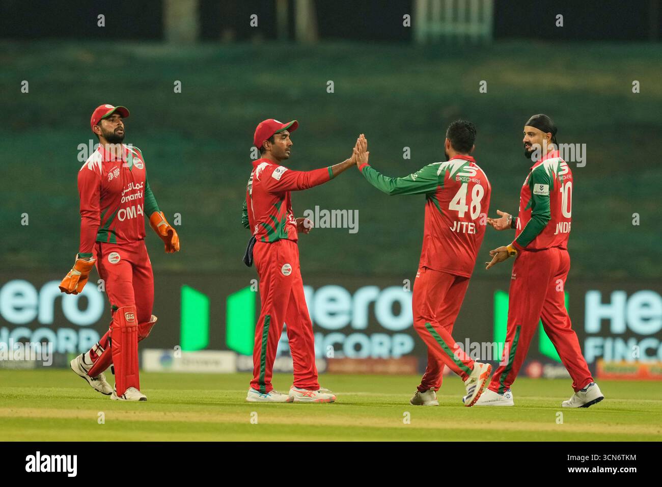 Oman's Jitenkumar Ramanandi, second right, celebrates with teammates ...