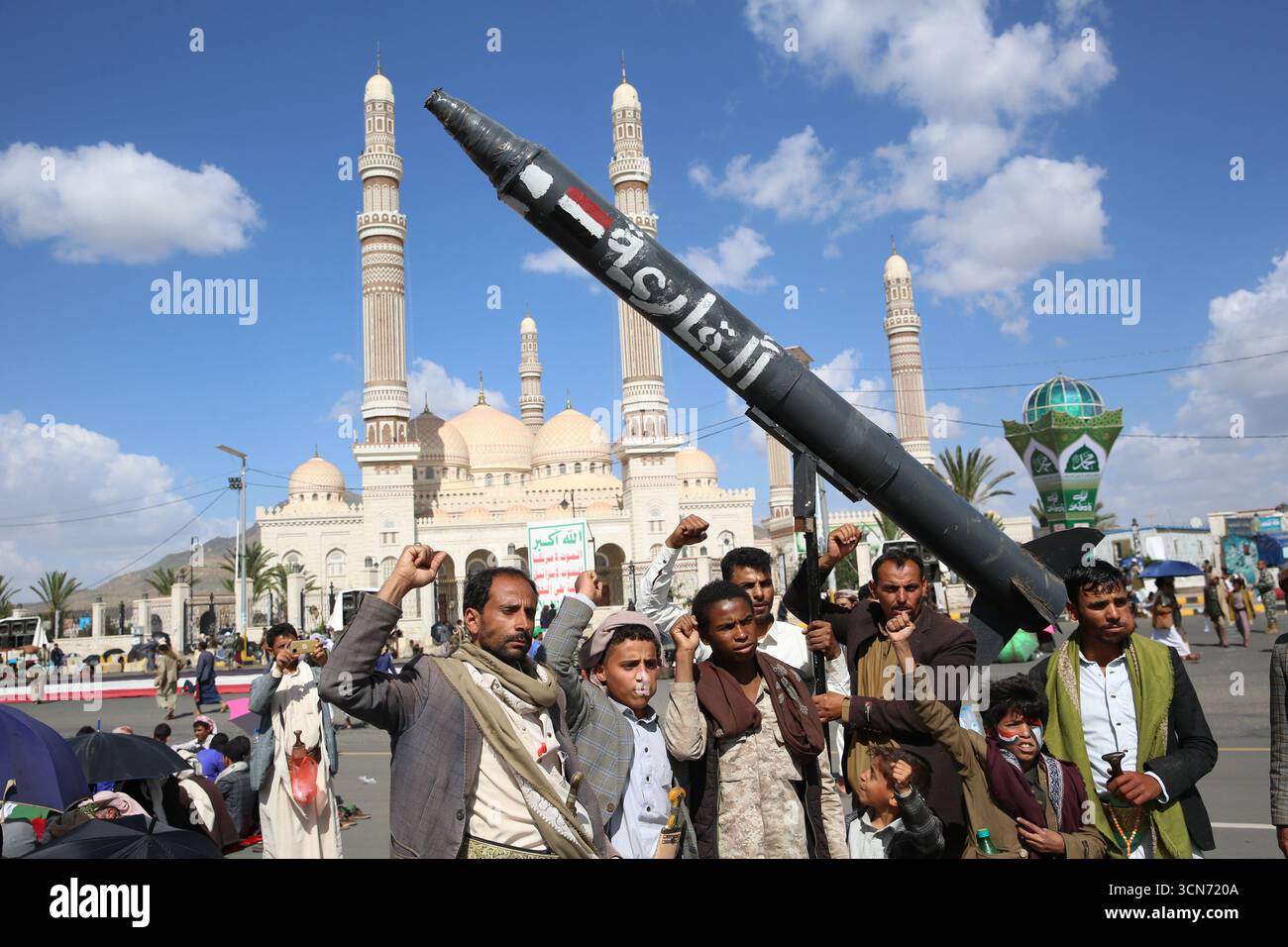 Houthi supporters display a mock rocket during an anti-Israel protest ...