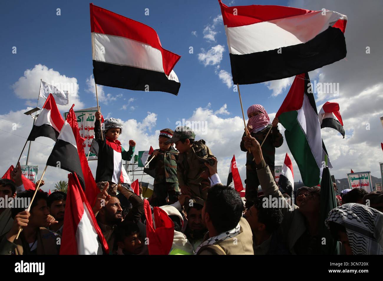 Houthi supporters hold placards and wave flags during an anti-Israel ...